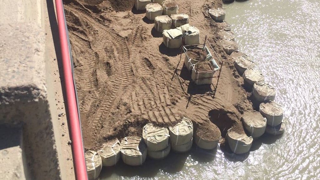 Fabric containers facilitate bridge-widening equipment, divert river